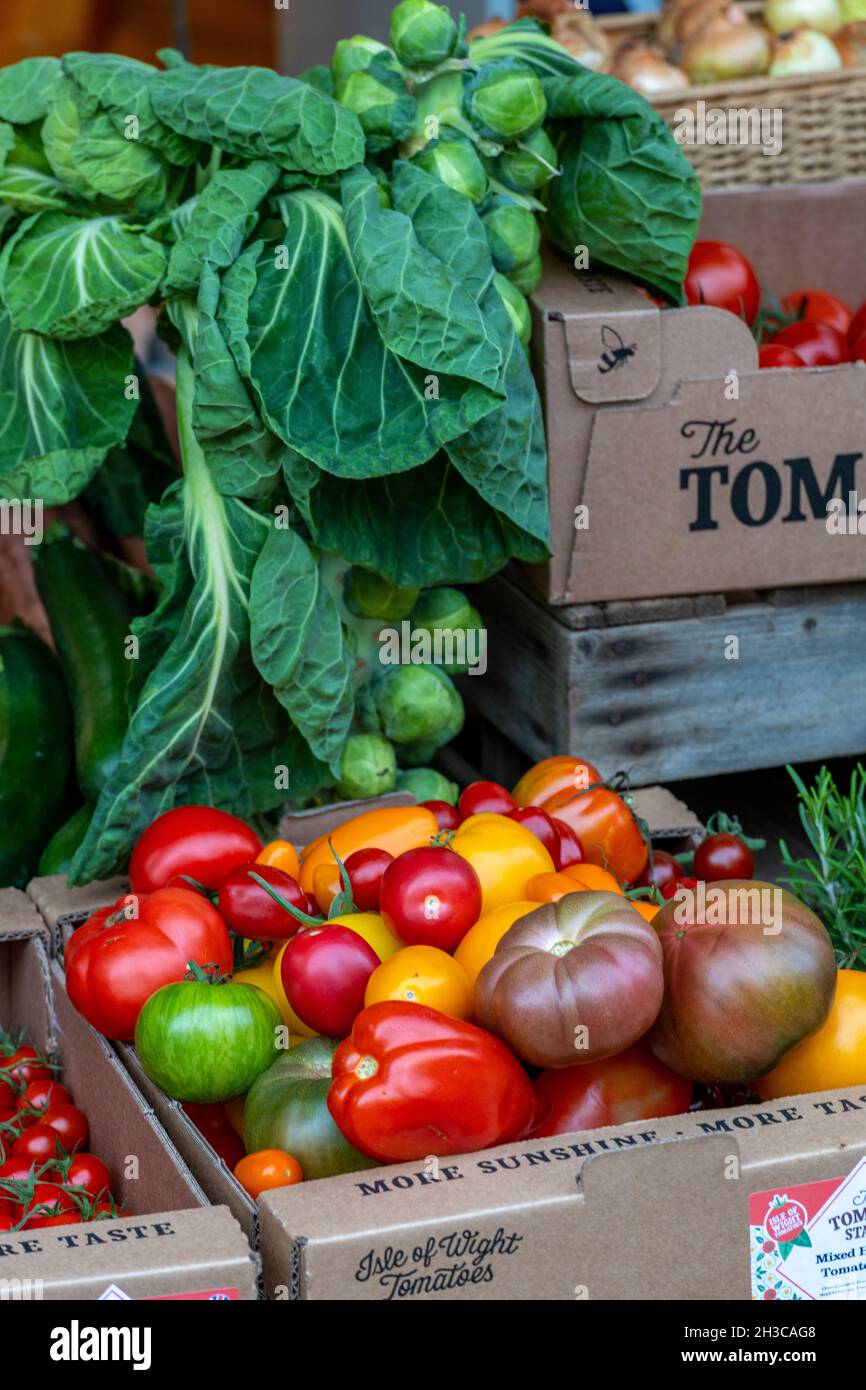 fresh tomatoes at a fruit and vegetable stall on a market, tomatoes ...