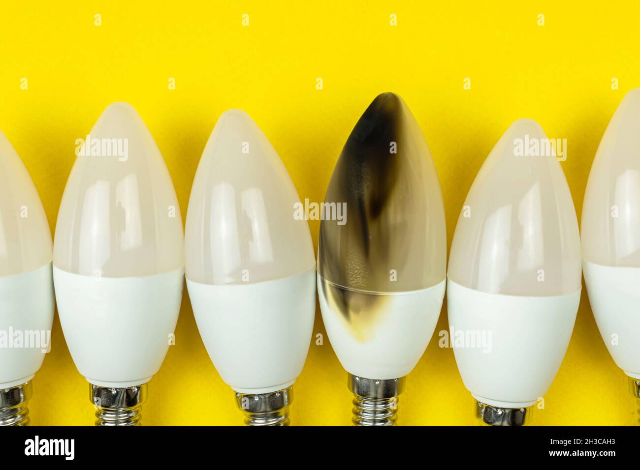 Burned and damaged LED light bulb after fire, electrical short circuit ...