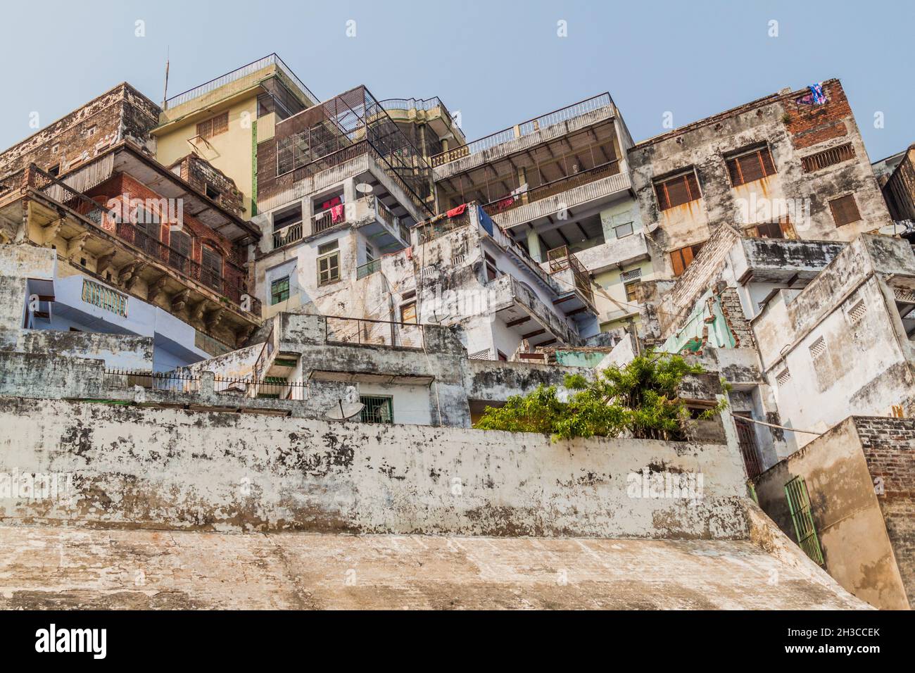 Buildings at a Ghat riverfront steps of sacred river Ganges in Varanasi ...