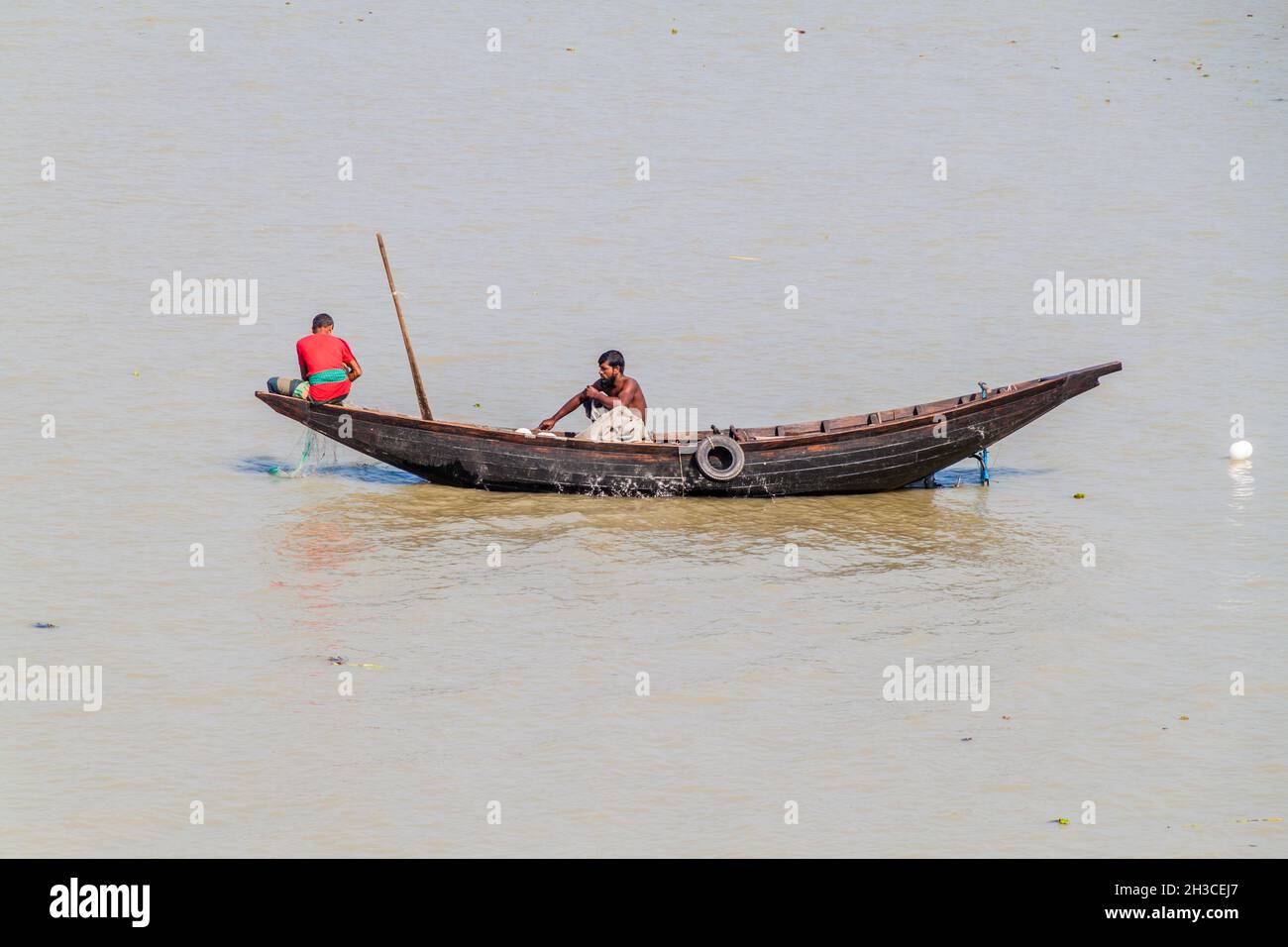 KATCHA RIVER, BANGLADESH - NOVEMBER 19, 2016: Fishermen on a small boat ...