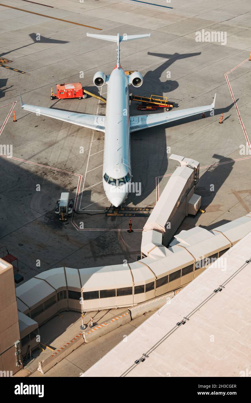 an American Eagle Canadair CRJ-900 regional jet parked at the gate at ...