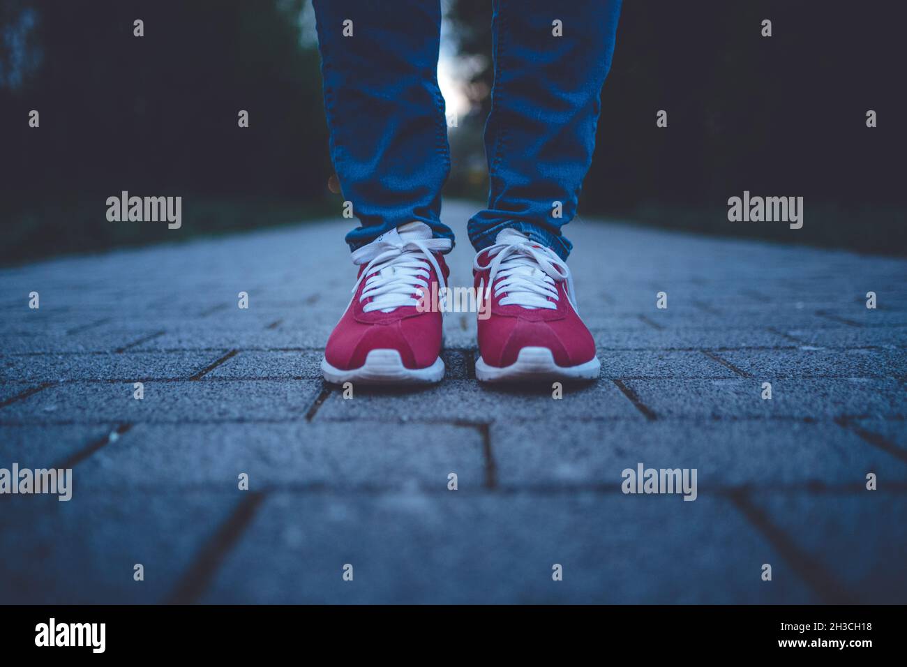 Red shoes on a path during blue hour Stock Photo - Alamy