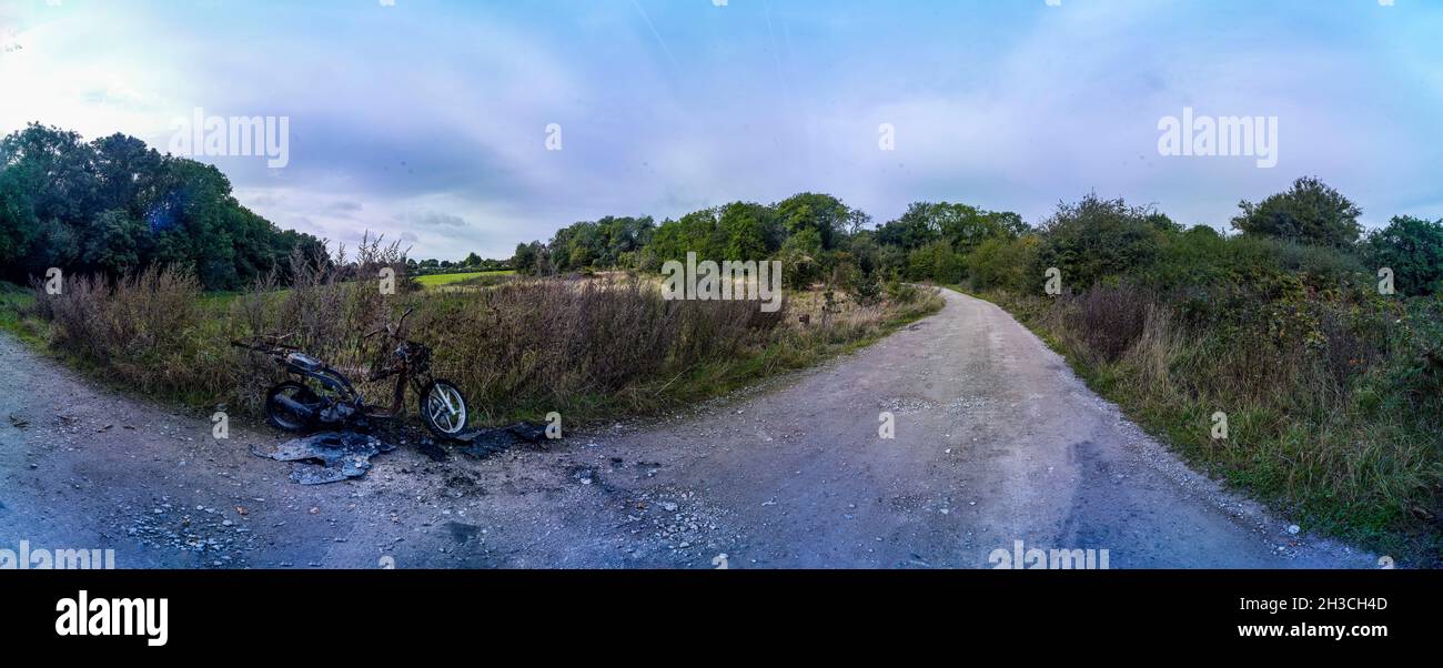 Wide landscape with burned out bike on recreational land Stock Photo ...