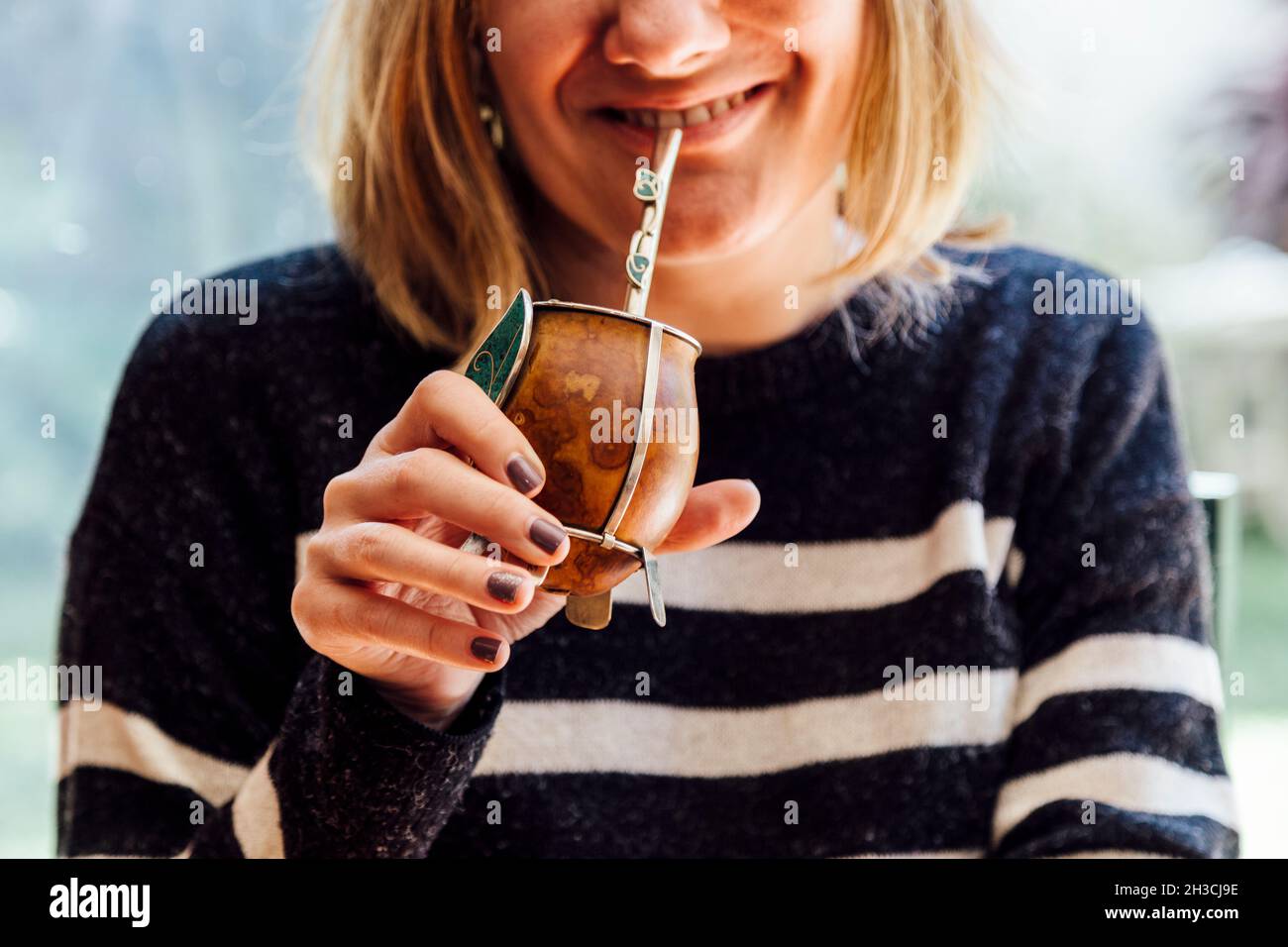 Mate ready to be drunk in the hands of an Argentine woman. Yerba Mate ...