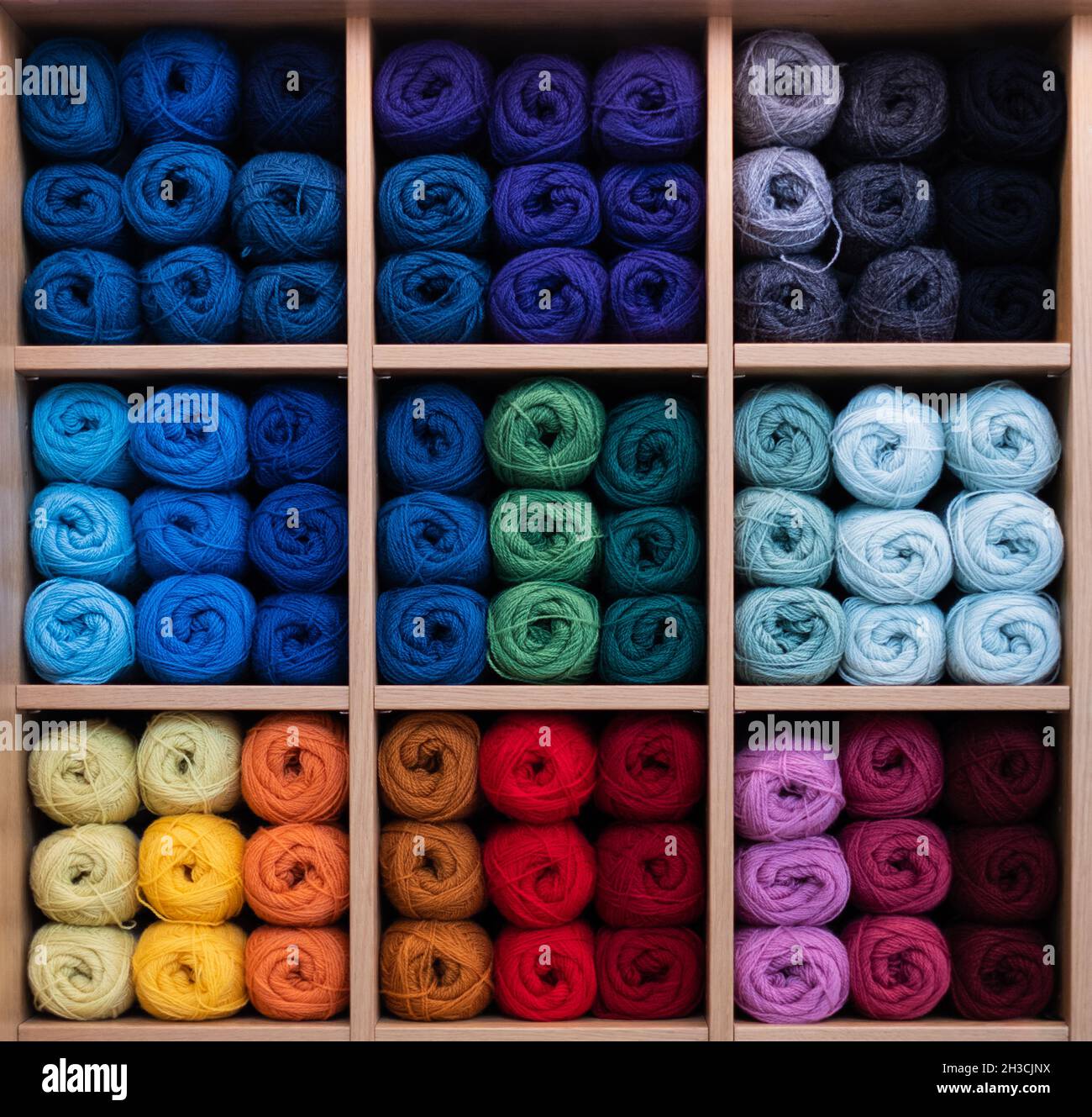 Colorful balls of yarn in shop display. Multi-color wool. Handcraft and ...