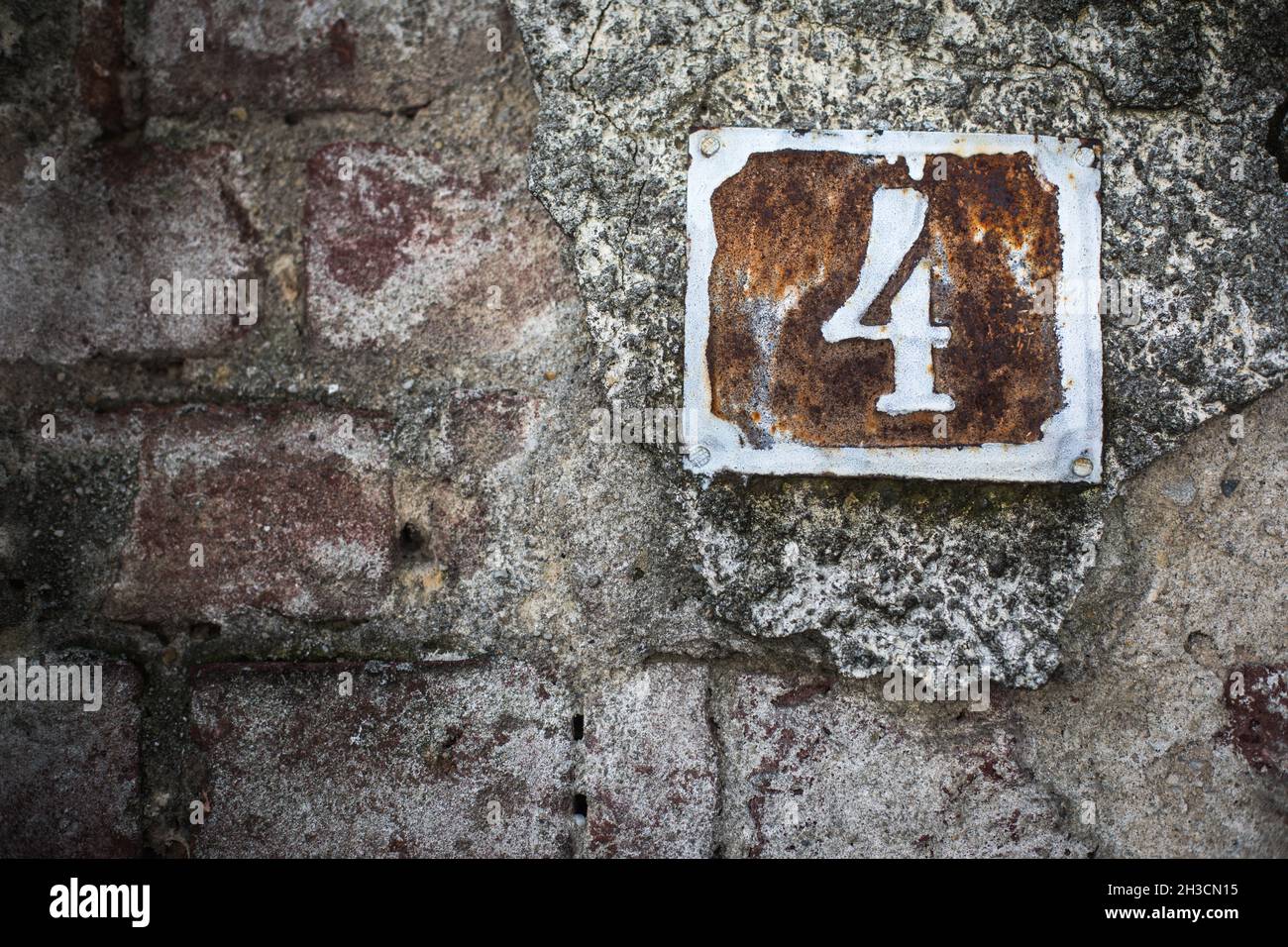 Number 4 plaque on a dirty old house wall Stock Photo - Alamy