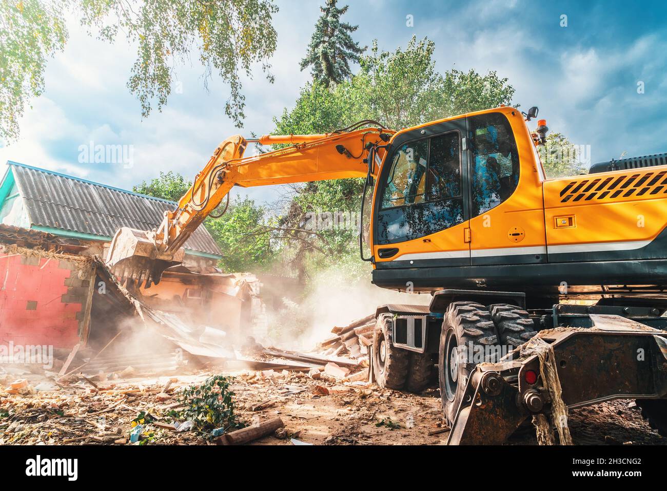 Building demolition. Excavator breaks house. Space for construction new ...