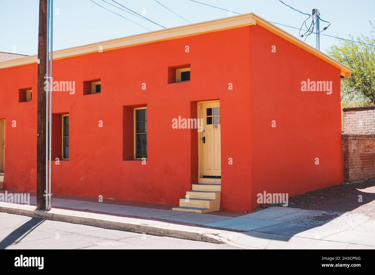 The front of a bright orange adobe (mudbrick) building in Barrio Viejo ...