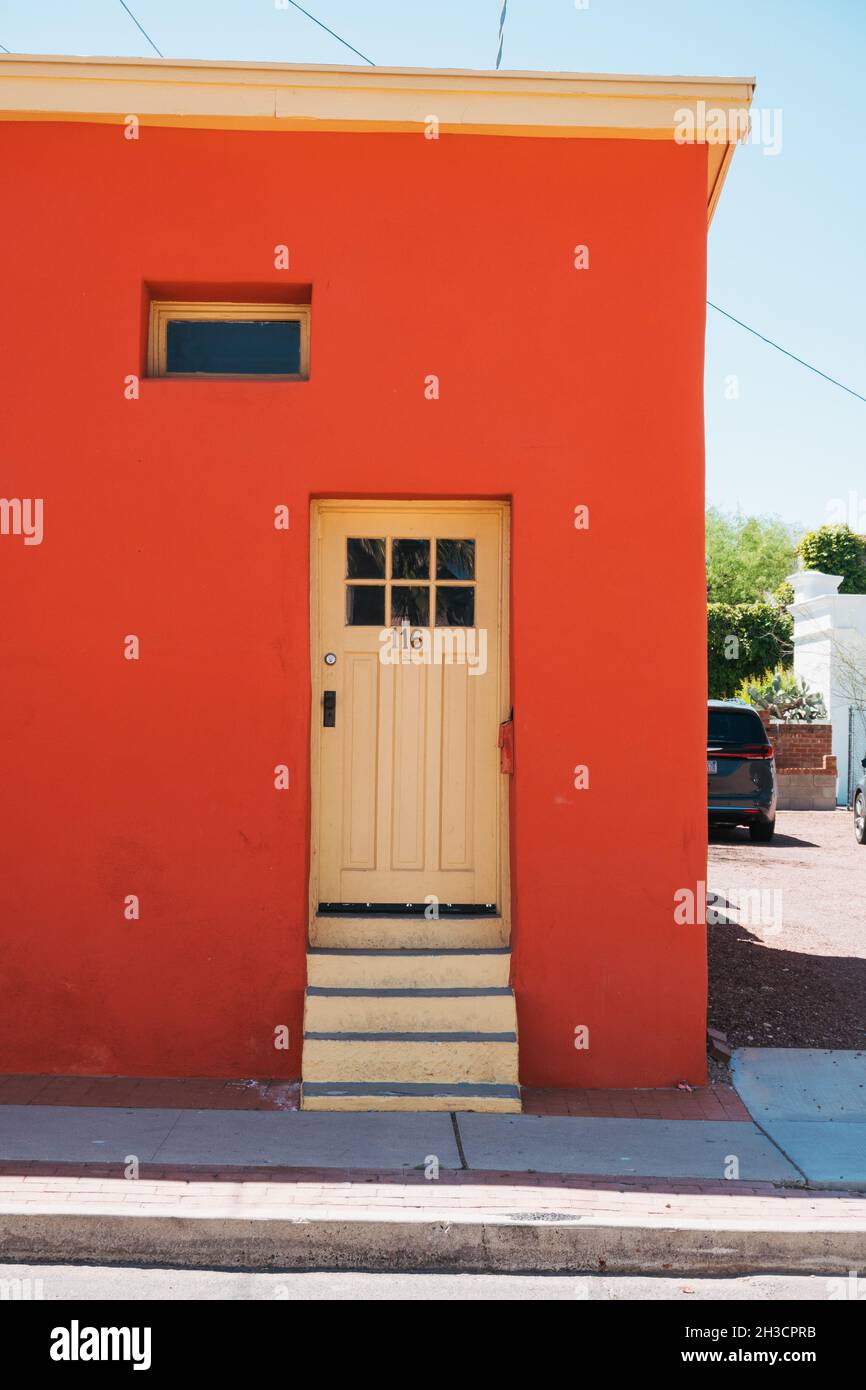The front of a bright orange adobe (mudbrick) building in Barrio Viejo ...