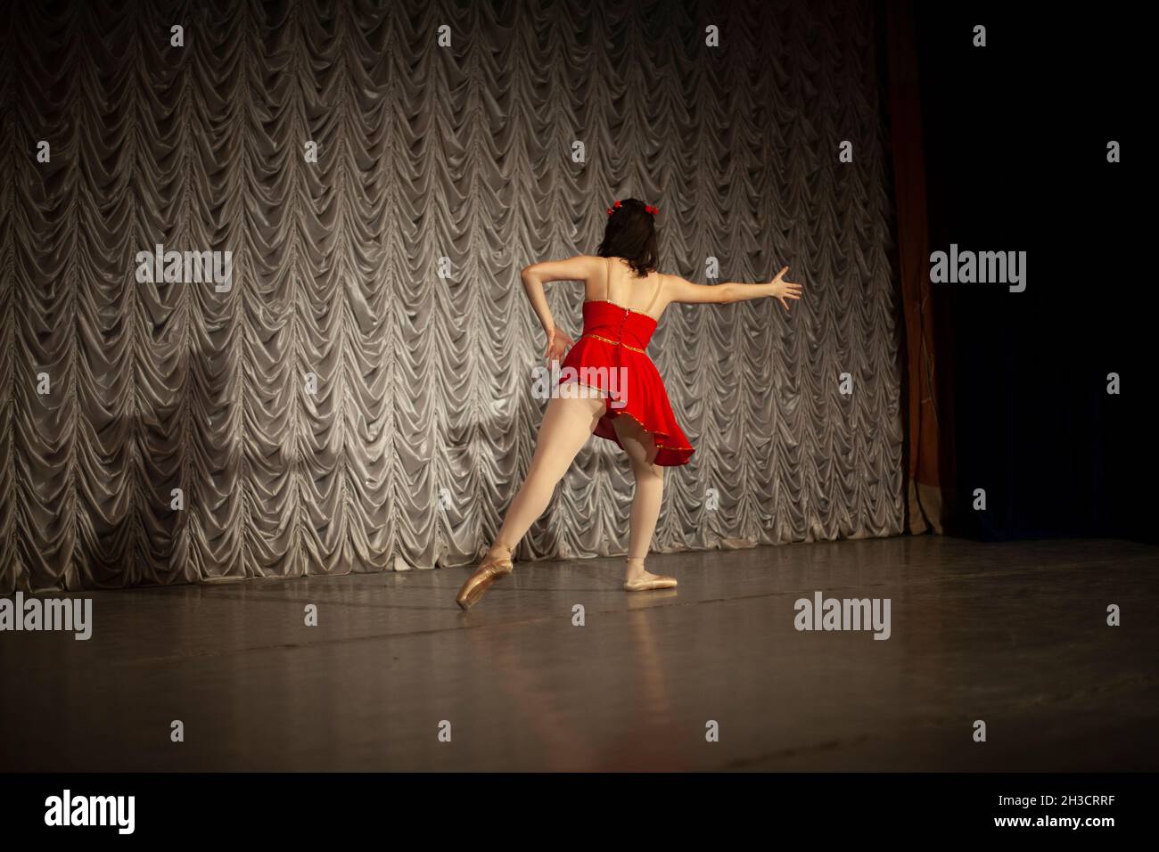 Dancer on stage. A girl in a red dress. Performance of the actress ...