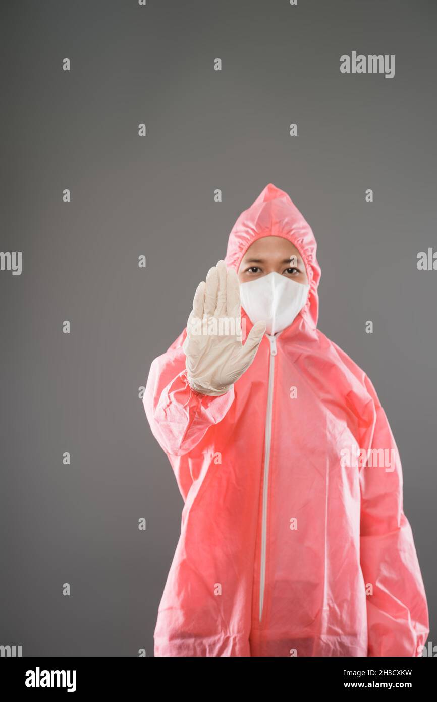 Health worker wear personal protective equipment with palms forward as ...