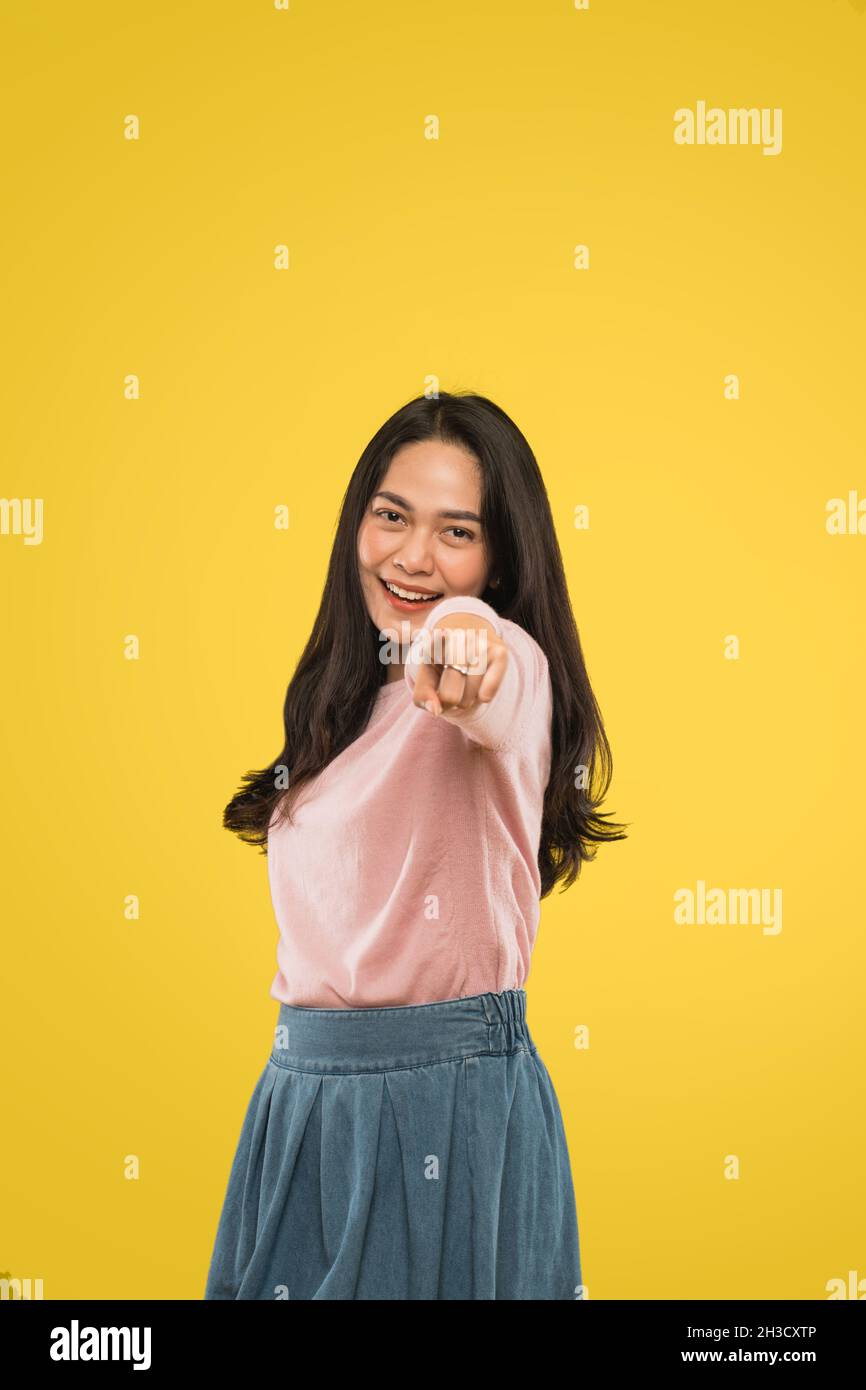 attractive woman smiling happily with one hand pointing forward Stock ...