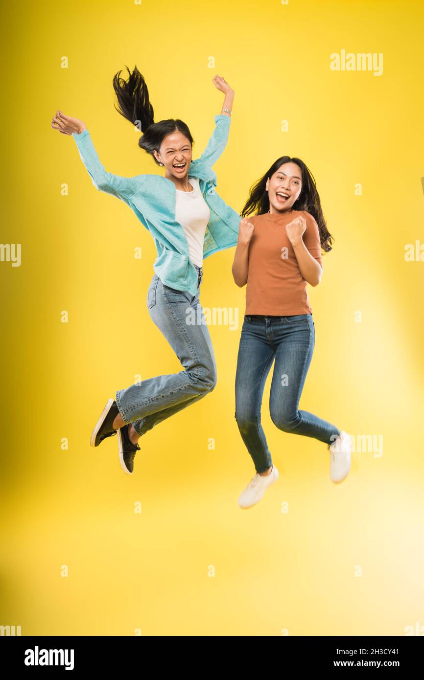 Beautiful girl jumping up together hi-res stock photography and images ...