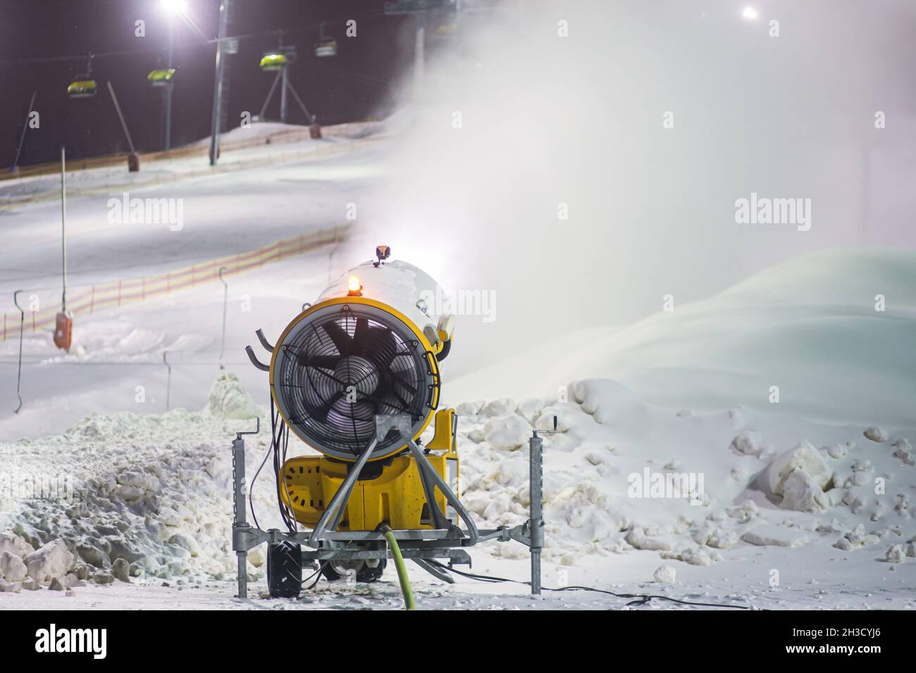 Snow cannon gun, artificial snow making machine on the slopes of a ski ...