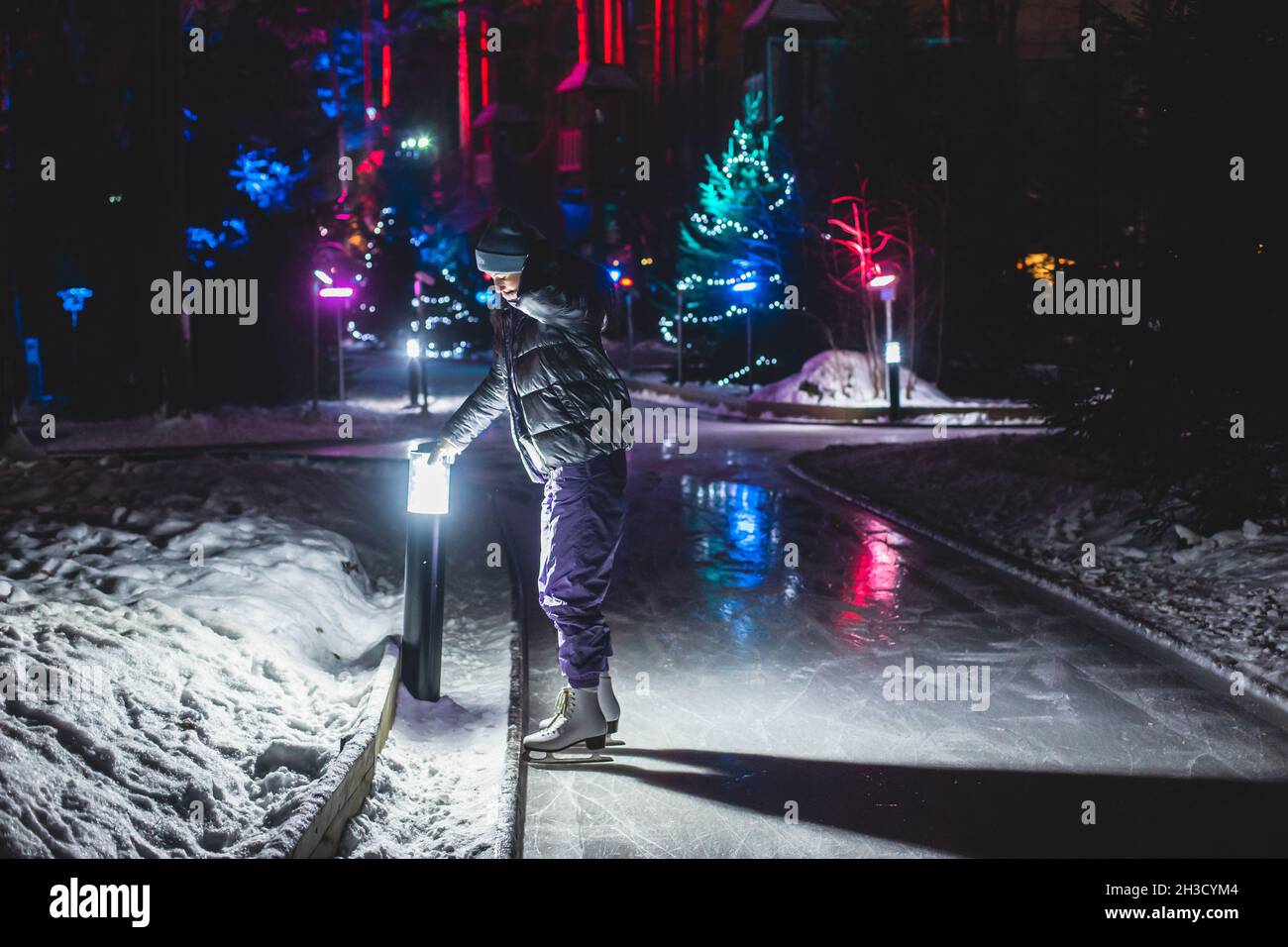 Girl ice skating on the ice rink arena with happy people around ...