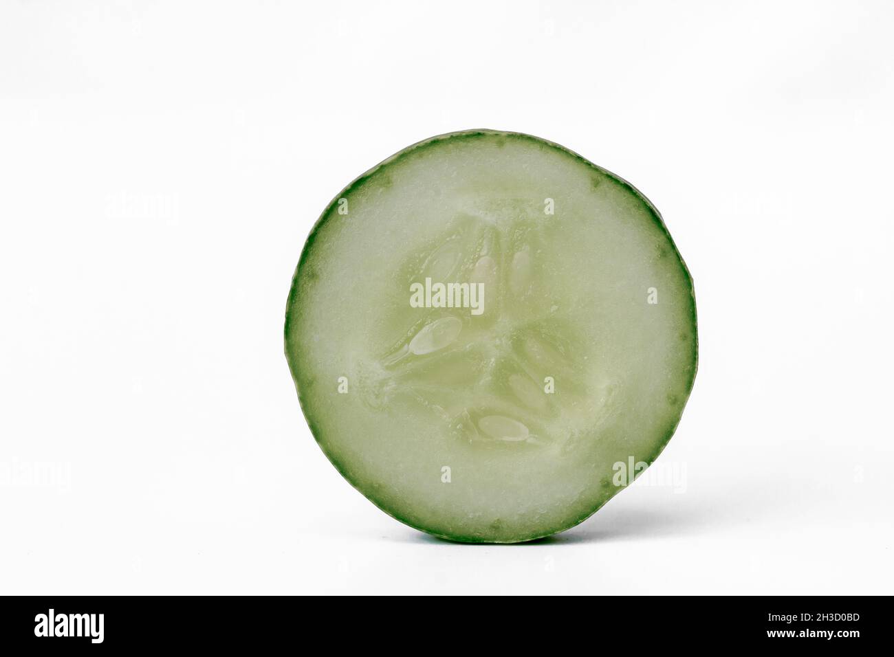 One slice of cucumber for fresh vegetables, isolated on white ...