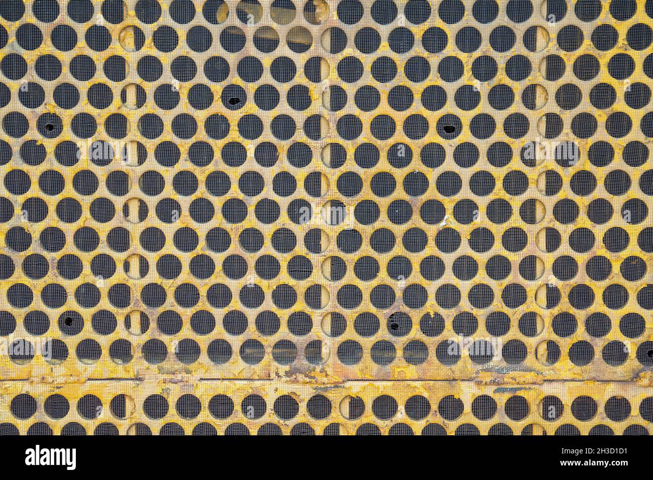 round hole perforated steel yellow and rusty Stock Photo - Alamy
