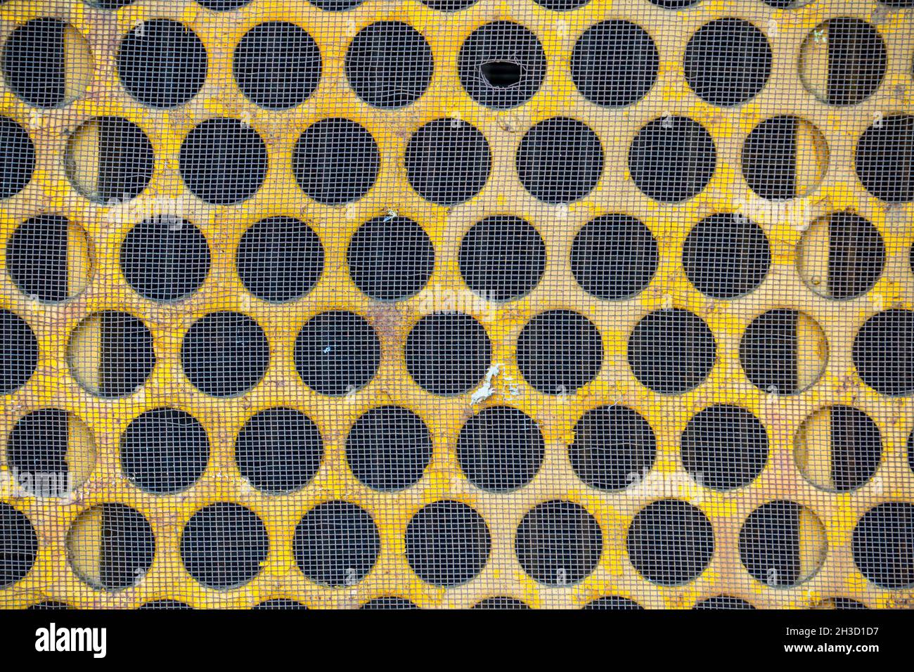 round hole perforated steel yellow and rusty Stock Photo - Alamy