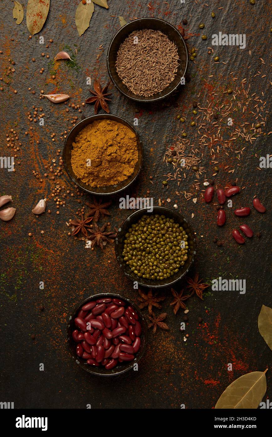 spices concept many colors and types of spices placed into spoons and ...