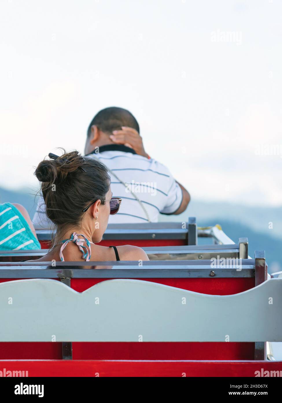 Back view of female passengers relaxing on balcony enjoying view from ...