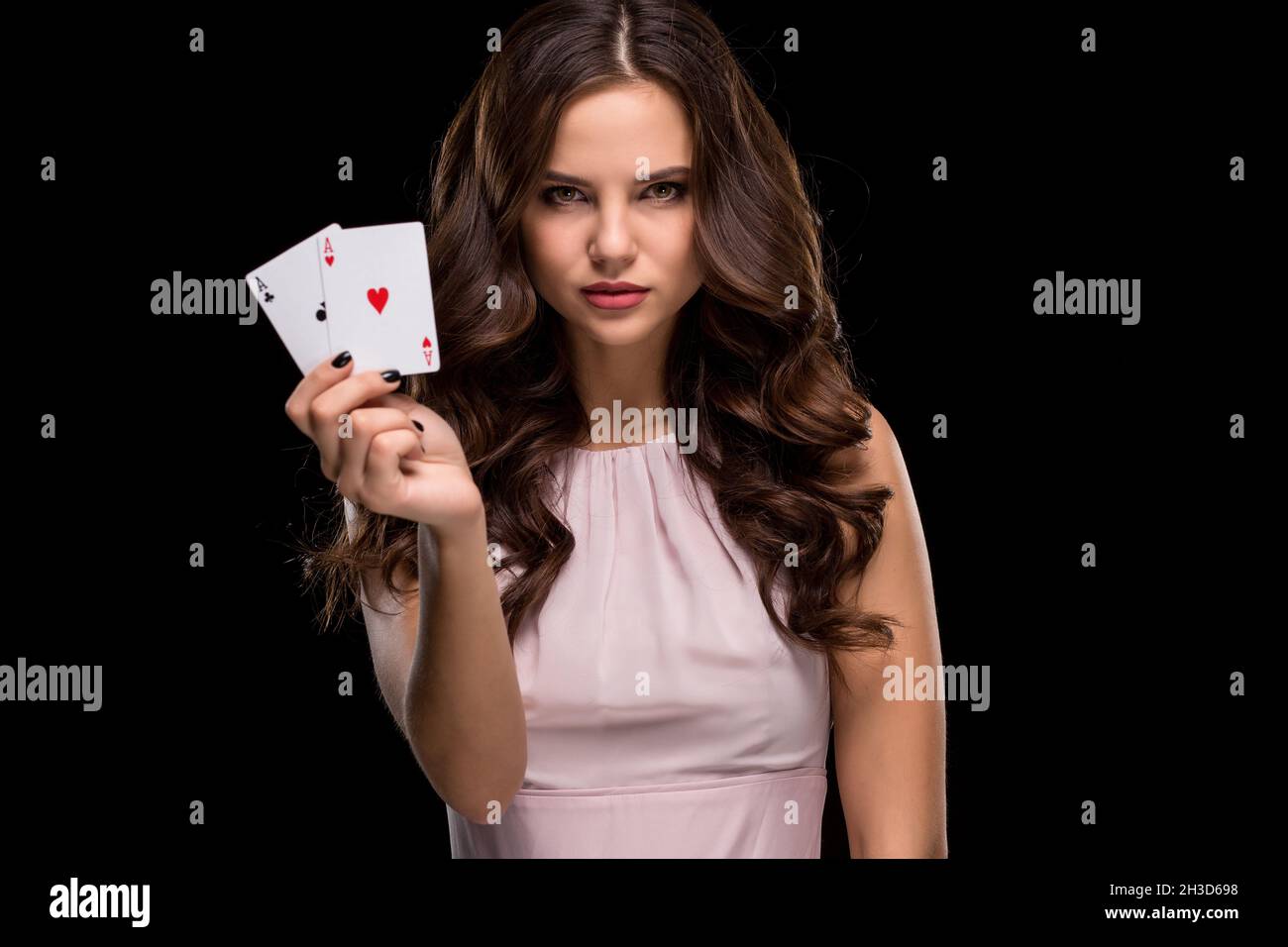 Attractive young woman holding the winning combination of poker cards ...