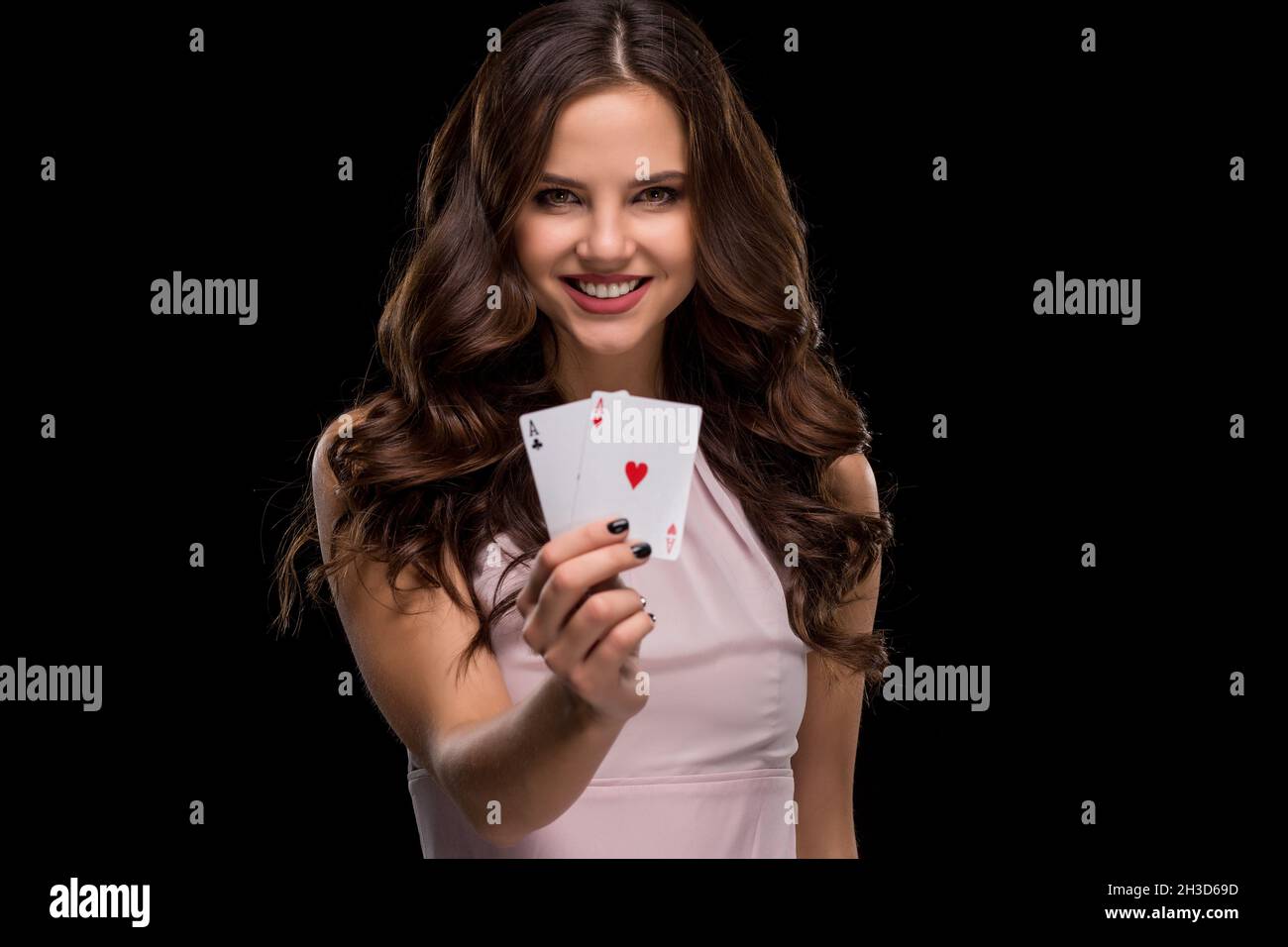 Attractive young woman holding the winning combination of poker cards ...