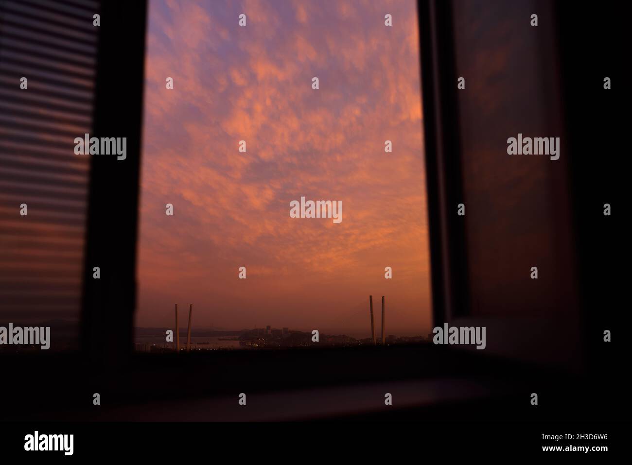 Sunset sky over city - view from window Stock Photo - Alamy
