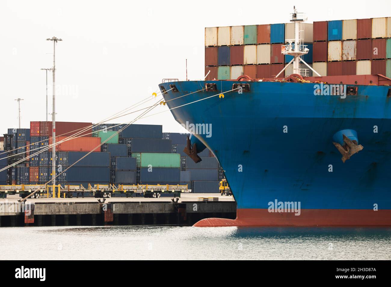 A cargo vessel full of containers sits docked at port Stock Photo - Alamy