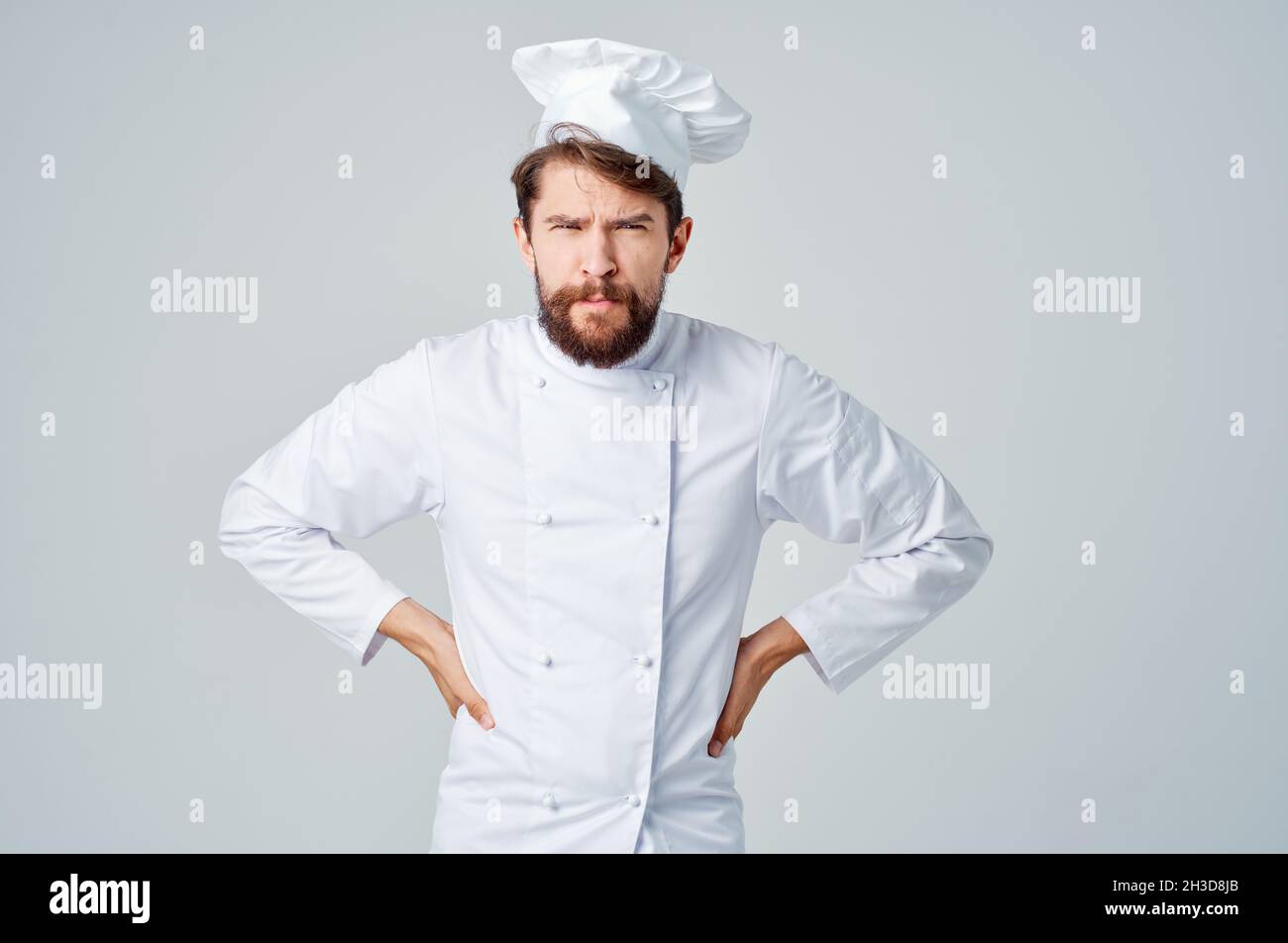 bearded man chef with bread in hand light background Stock Photo - Alamy