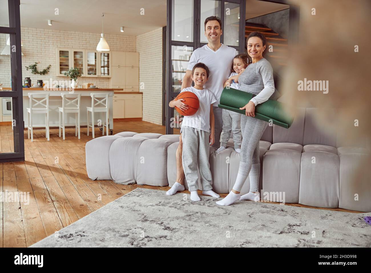 Happy family doing workout together at home Stock Photo - Alamy