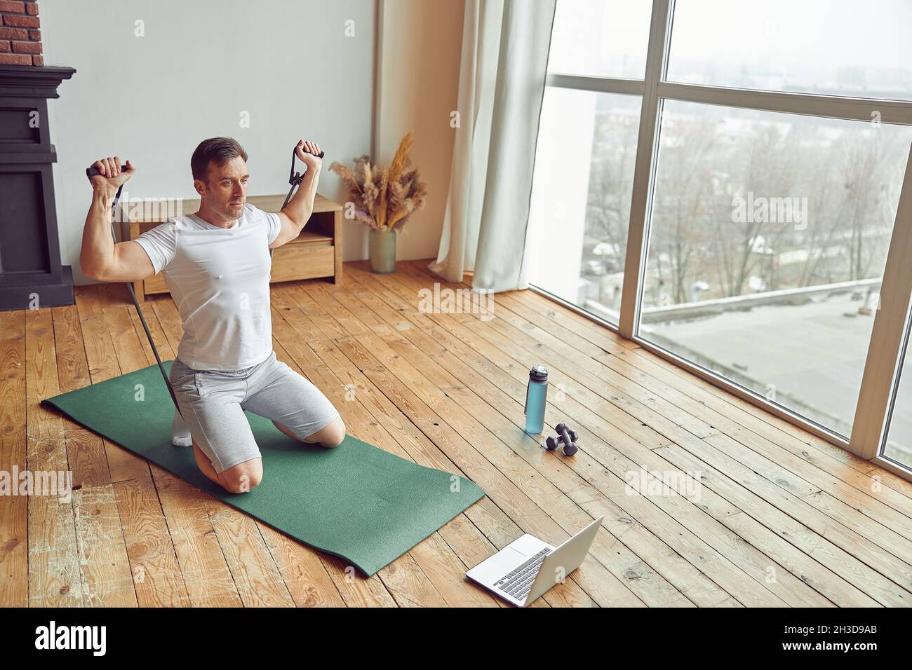 Man doing upper body online workout at home Stock Photo - Alamy