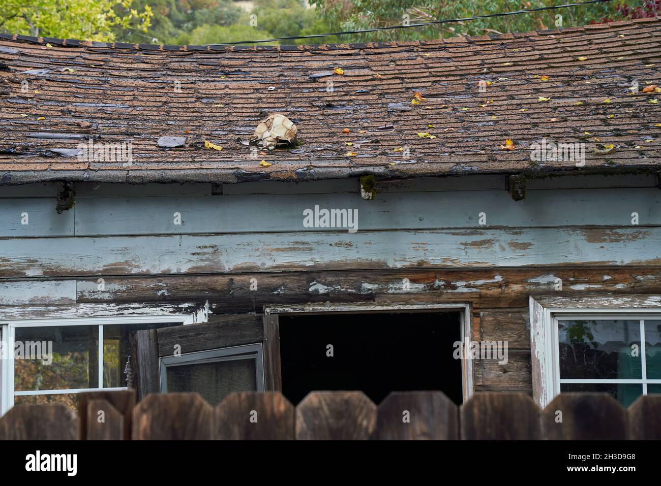 Deflated soccer ball rests on sagging roof of an abandoned house ...