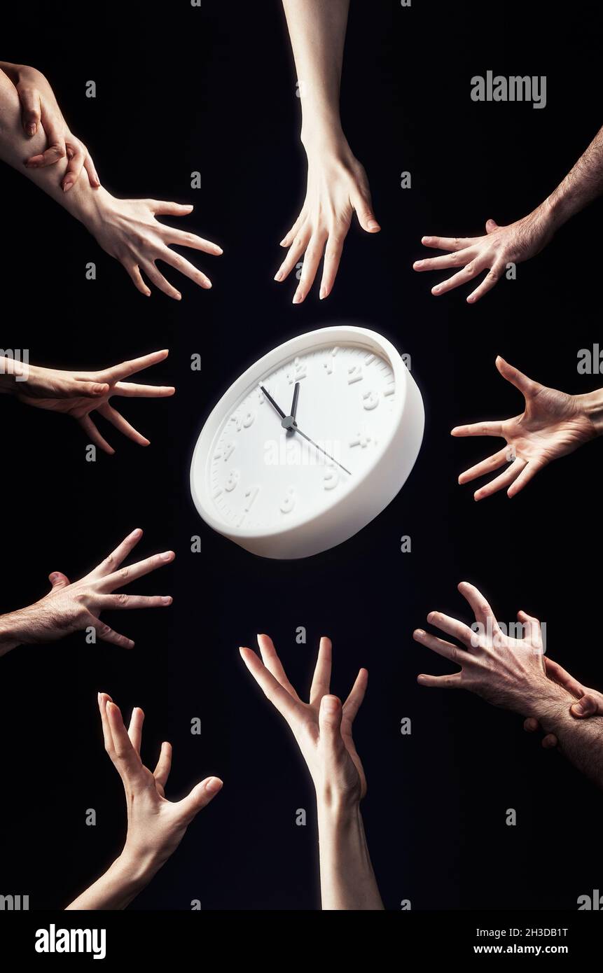 A crowd of people is drawn to the clock in the center. Hands close-up ...