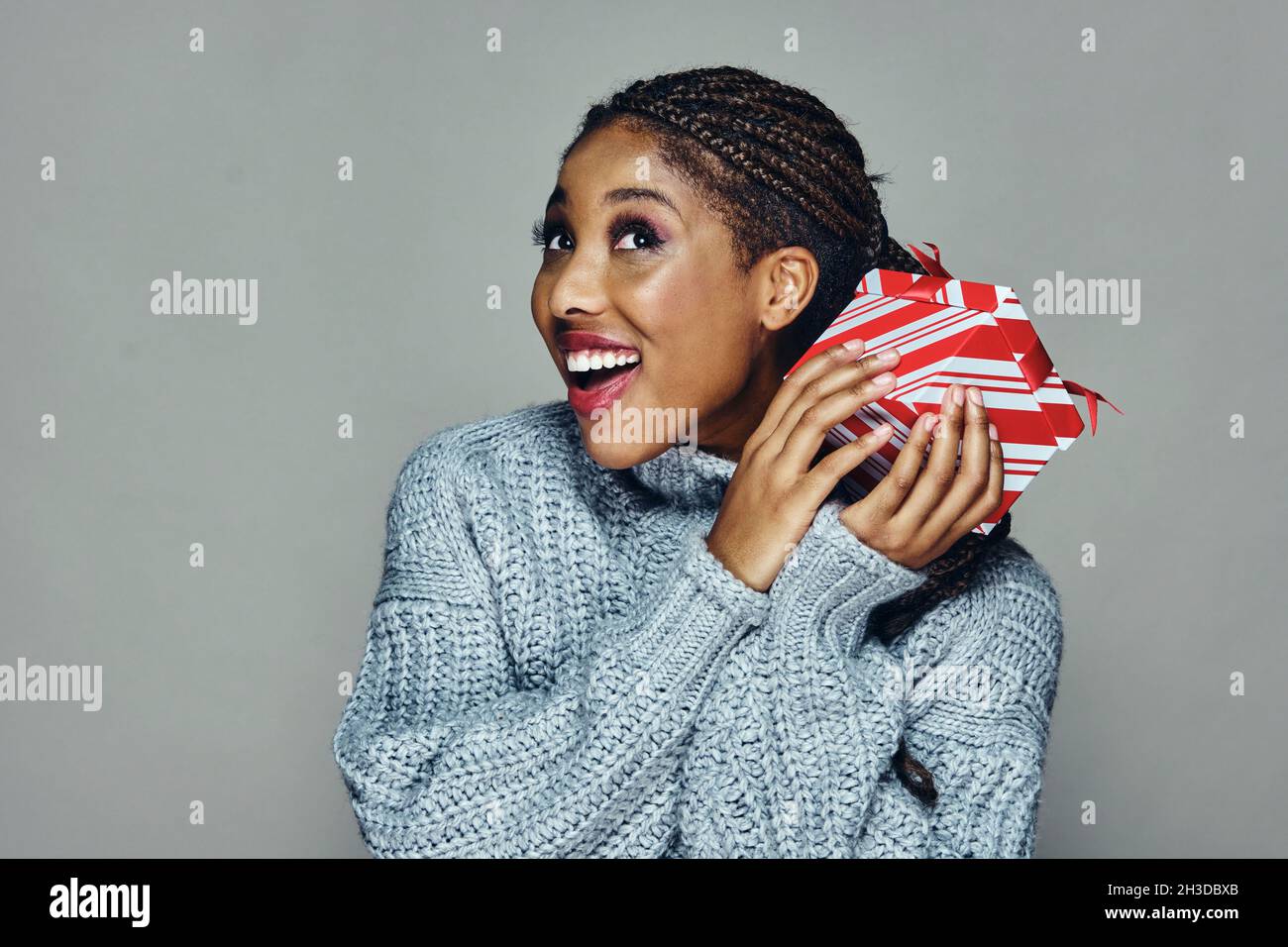Woman shaking gift box hi-res stock photography and images - Alamy