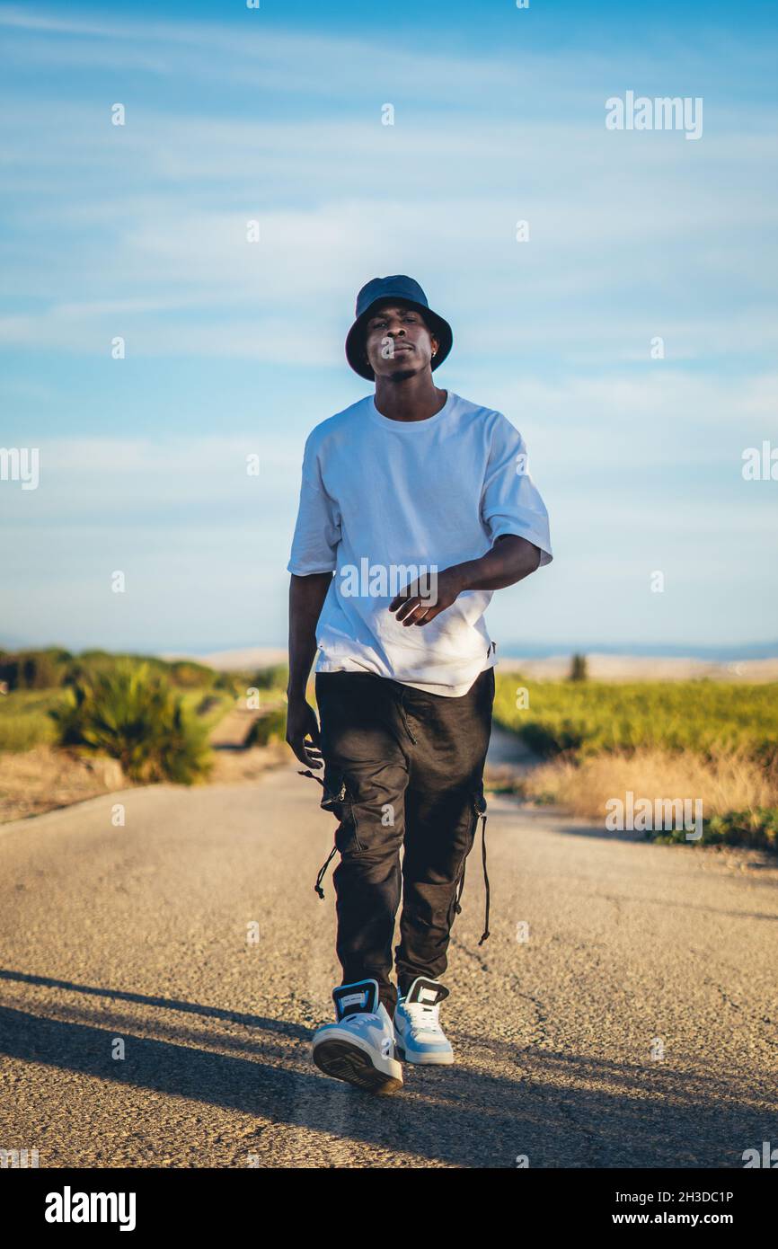 Full body shot of a young black handsome man wearing a bucket hat ...