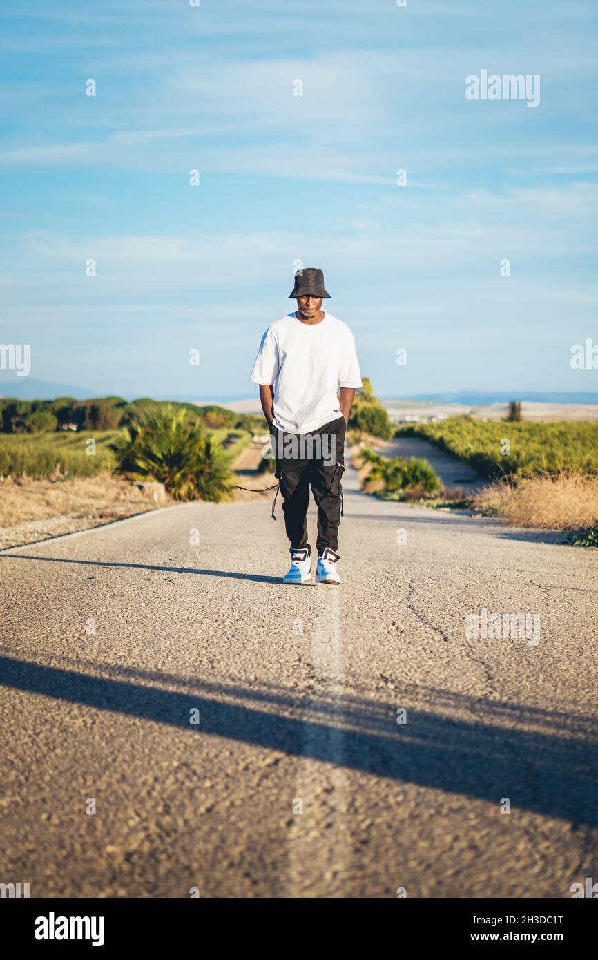 Full body shot of a young black handsome man wearing a bucket hat ...