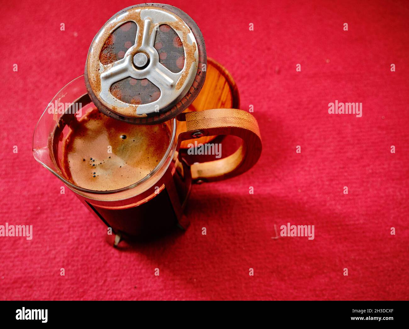 Delicious arabica coffee made by french press technique standing on red ...