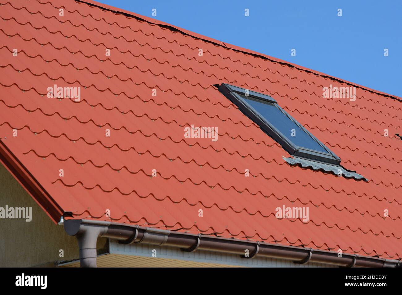 Close up on metal roof with attic skylight window and gutter Stock ...