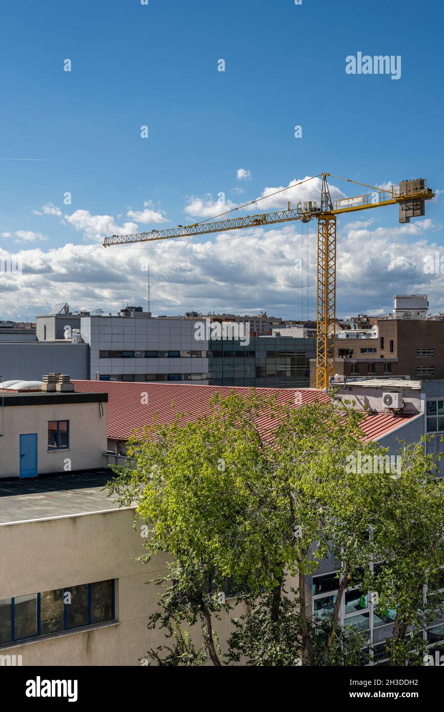Building construction crane in the middle of the city with sky full of ...