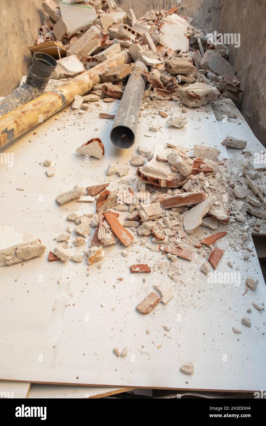 Masonry rubble inside a metal urban waste container Stock Photo - Alamy