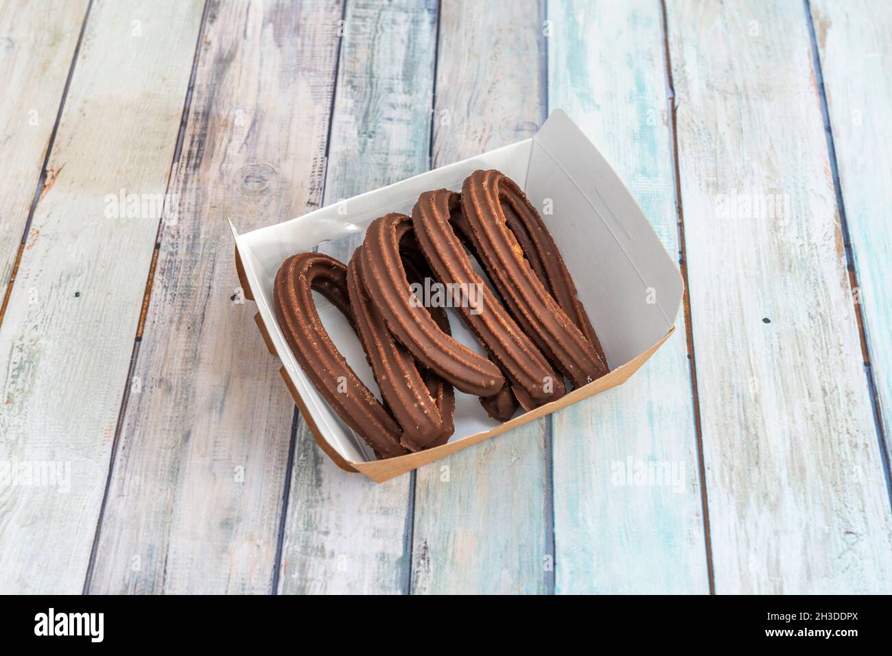 chocolate covered churros takeaway carton tray Stock Photo - Alamy