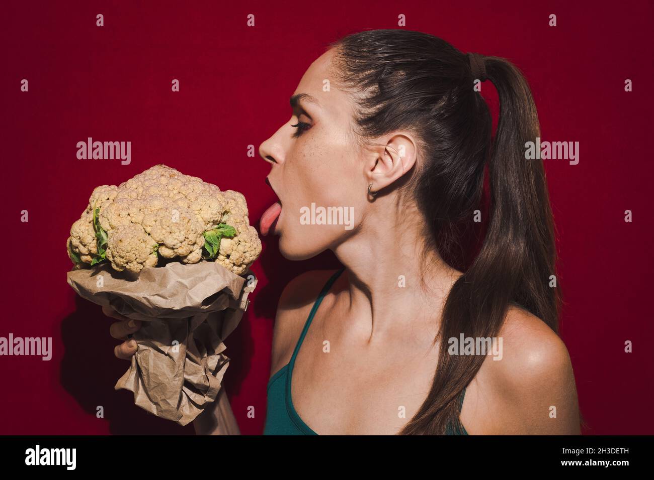 Cheeky model posing with cauliflower Stock Photo - Alamy