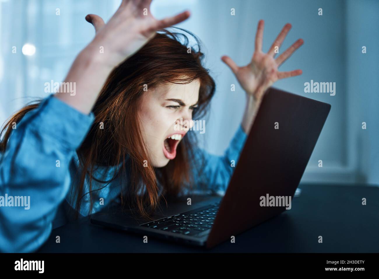emotional woman in front of laptop at night work disorder Stock Photo ...