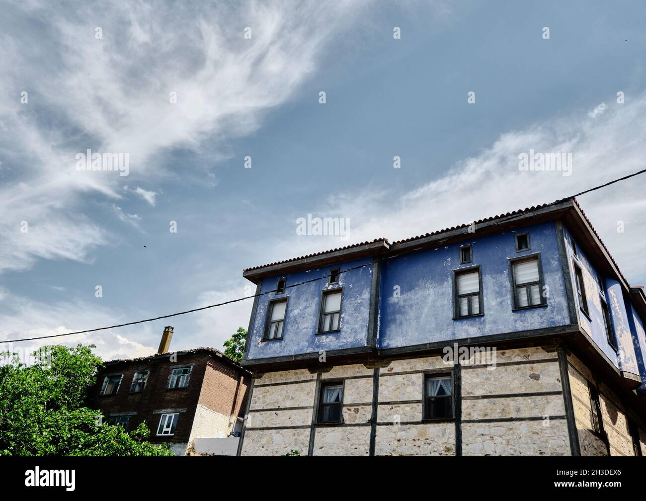Old ottoman style house with blue color and narrow street with sunshine ...