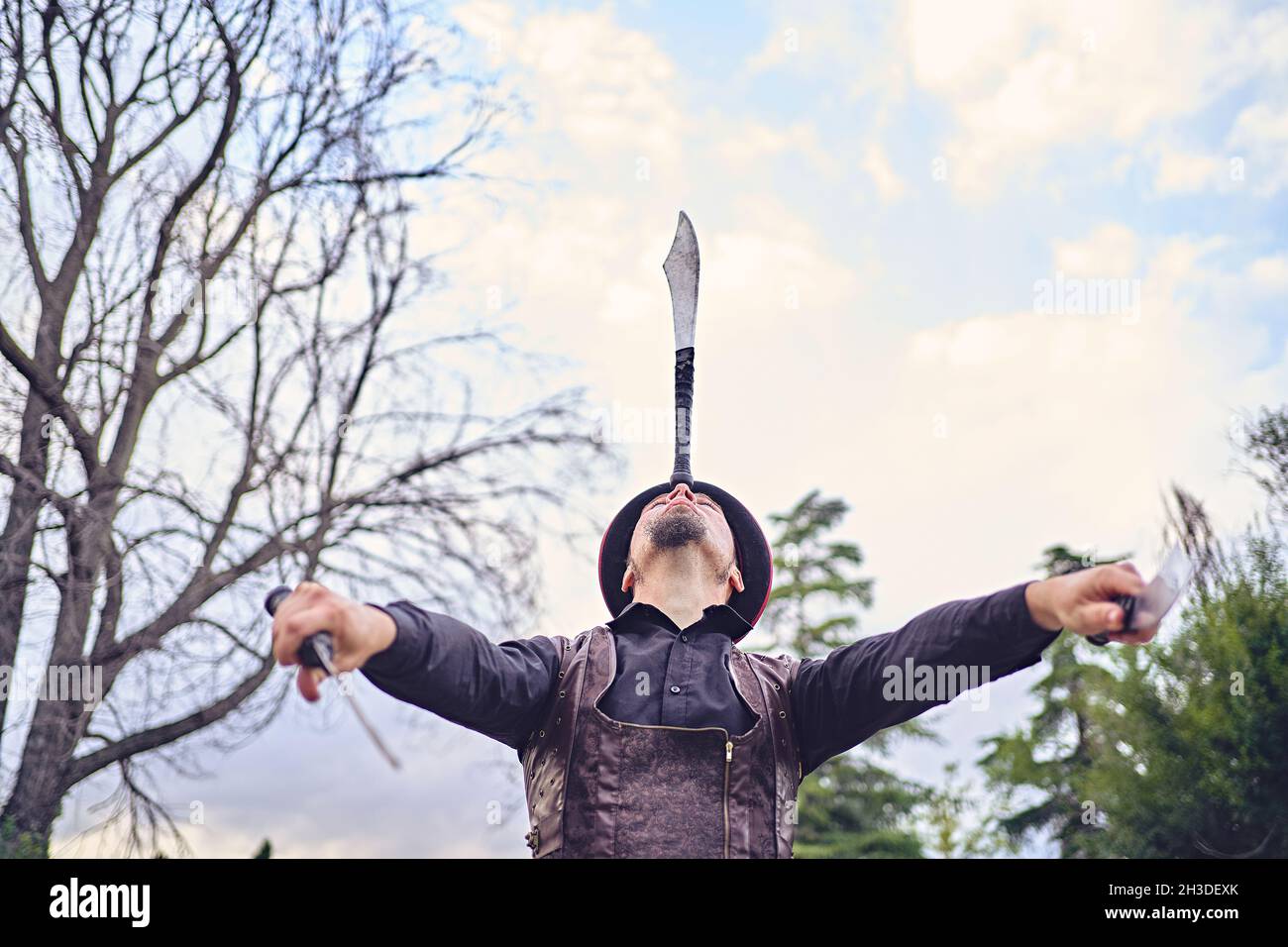 Funny male performer juggling knives during show in the park Stock ...