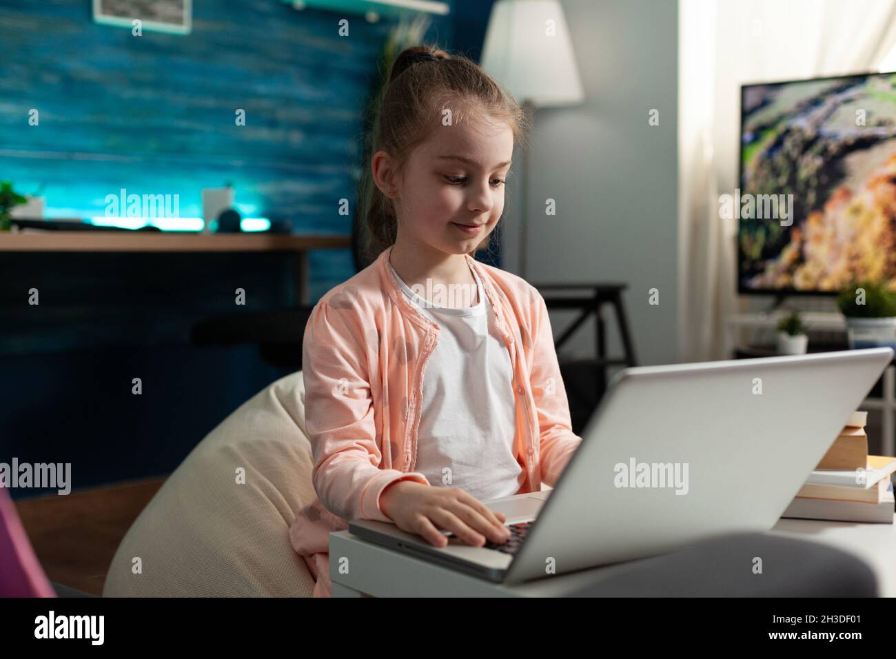 Clever schoolchild working at literature homework browsing educational ...
