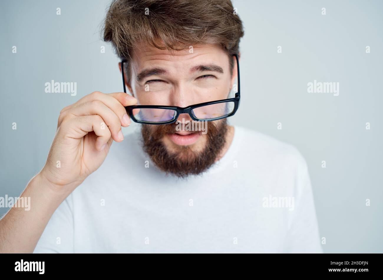 man vision problems in white t-shirt isolated background Stock Photo ...