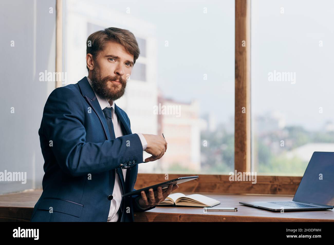 businessmen near the window with a laptop self-confidence Stock Photo ... businessmen near the window with a laptop self-confidence Stock Photo ...