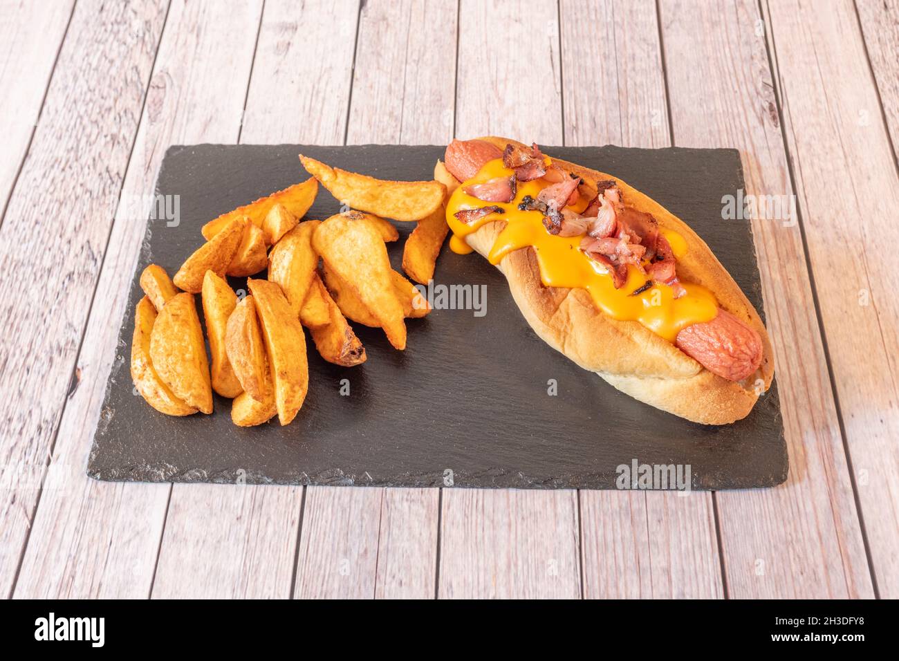 Hot dog with lots of melted cheddar cheese, chunky fried bacon and ...