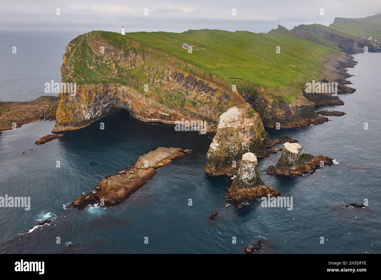 Mykines lighthouse and cliffs on Faroe islands from helicopter. Denmark ...
